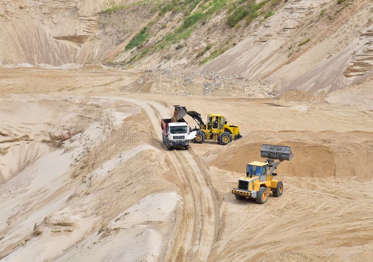 Wheel Front-end Loader Loading Sand into Heavy Dump Truck at the ...