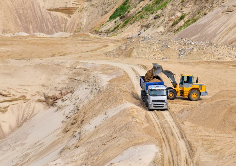 Wheel Front-end Loader Loading Sand into Heavy Dump Truck at the ...