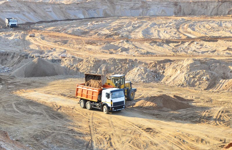 Wheel Front-end Loader Loading Sand Into Heavy Dump Truck At The ...