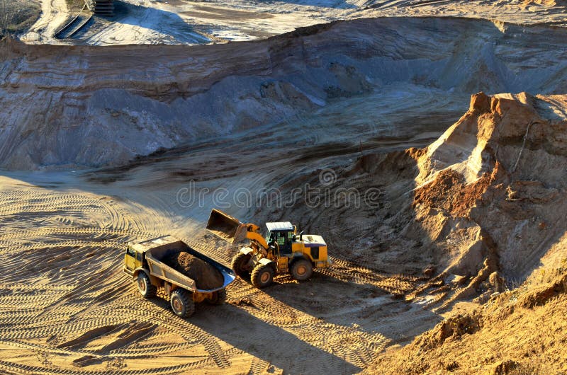 Wheel Front-end Loader Unloading Sand into Heavy Dump Truck at the ...