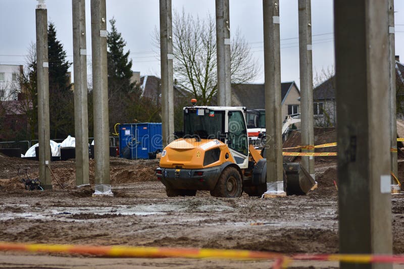 Wheel Loader Digging and Pushing Ground Around Building Columns. Stock ...