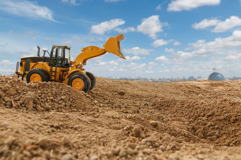 Wheel Loader are Digging the Soil in the Construction Site on. Stock ...