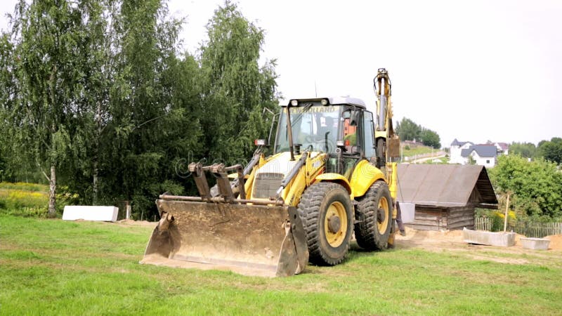 Wheel Loader. Excavator Install the Foundation Blocks into a Trench ...