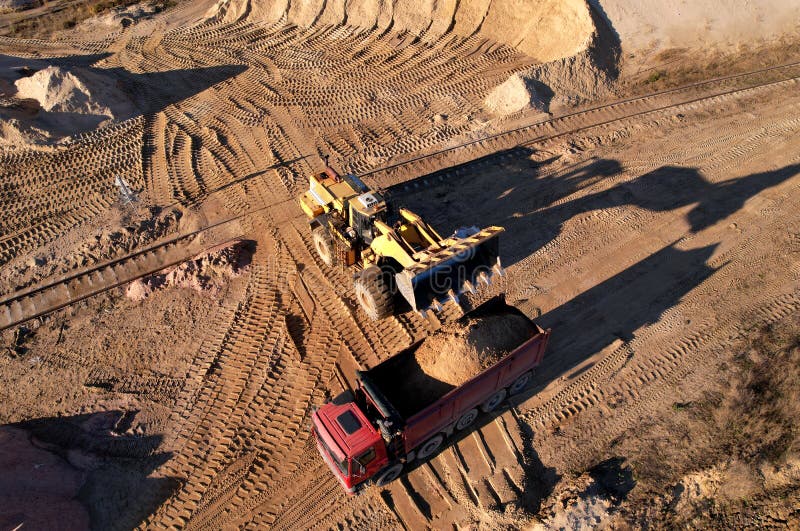 Wheel Loader Loads Sand into Heavy Mining Dump Truck at the Opencast ...