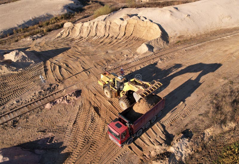Wheel Loader Load the Sand into Dump Truck in Open Pit. Developing the ...