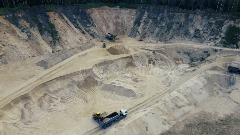 Wheel Loader Loading Sand into Dump Truck in Open Pit Mine. Arial View ...