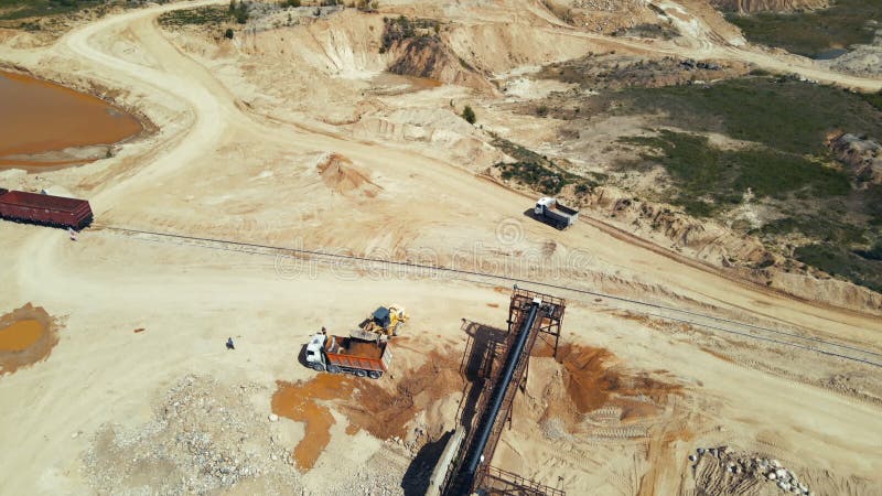 Wheel Loader Loads Sand into a Dump Truck. Aerial View of Open Pit ...