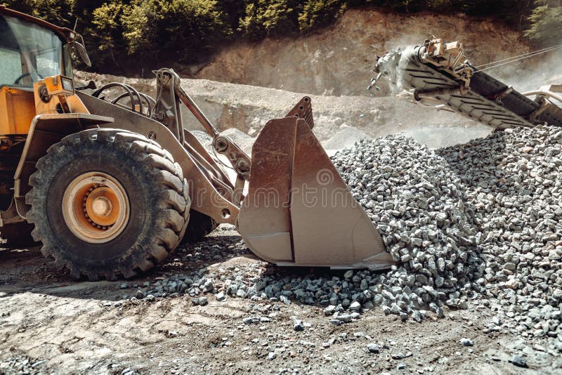Wheel Loader Machine Unloading Rocks in the Open Pit Mine and Ore ...