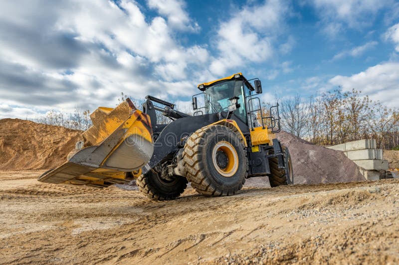 Wheel Loader Rides on a Construction Site. Stock Image - Image of ...