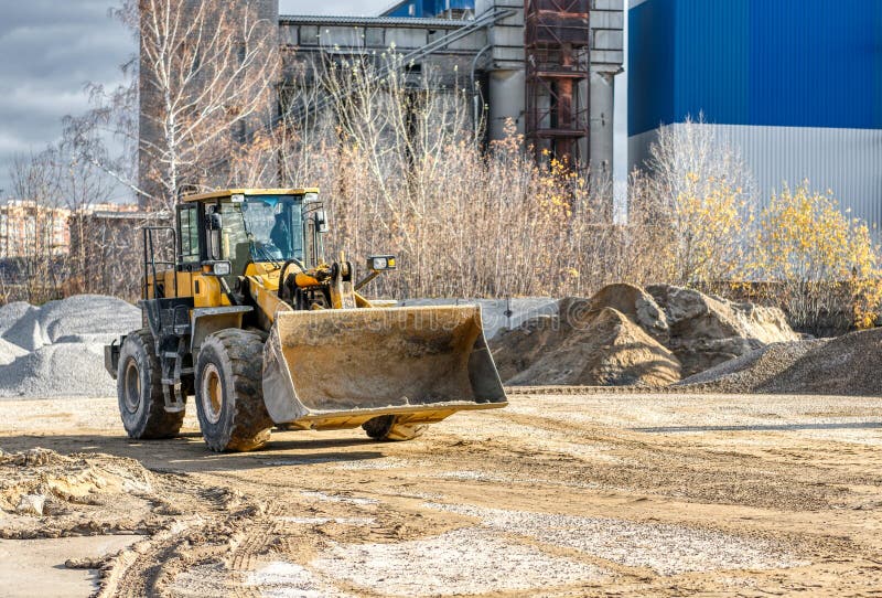 Wheel Loader Rides on a Construction Site. Stock Photo - Image of ...