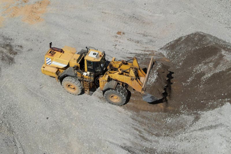 Wheel Loader Works in a Gravel Pit. Loading or Unloading Stone and ...