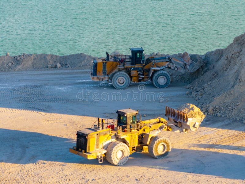 Wheel Loaders Loading Rock into a Dump Truck at a Quarry Stock Photo ...