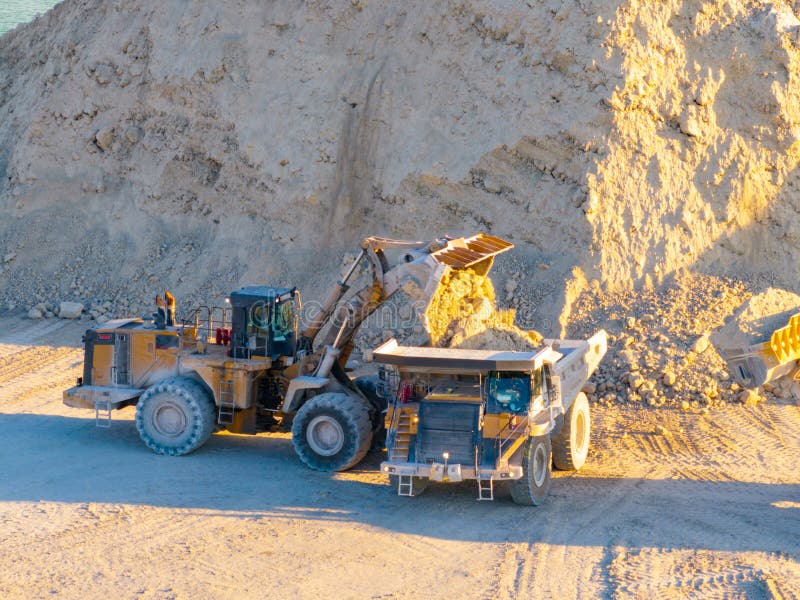 Wheel Loaders Loading Rock into a Dump Truck at a Quarry Stock Photo ...