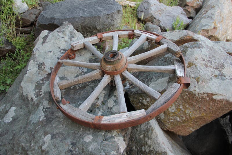 Wheel on the rock stock photo. Image of antique, rusty - 91917372