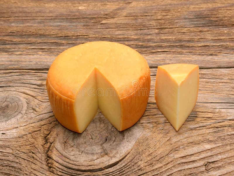 Cheese Wheel on Wooden Table Stock Photo - Image of wheel, traditional ...