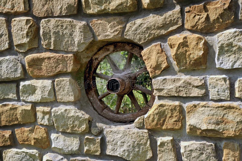 Wheel in the Wall Made of Stones Stock Image - Image of lining, race ...