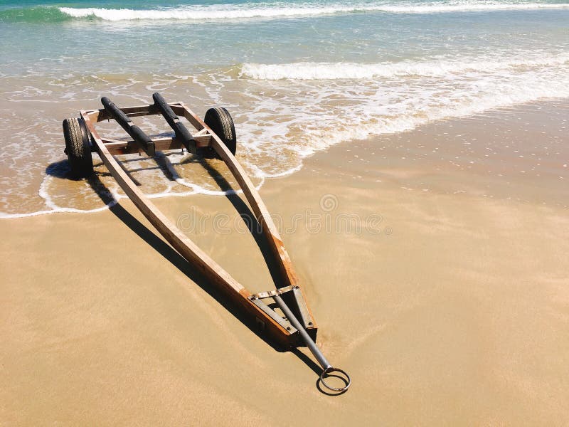 The Wheelbarrow on the Beach with Sea Wave Foam Stock Image - Image of ...