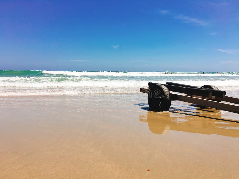 The Wheelbarrow on the Beach with Sea Wave Foam Stock Photo - Image of ...