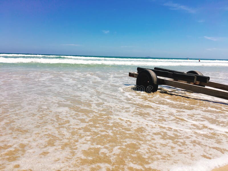 The Wheelbarrow on the Beach with Sea Wave Foam Stock Photo - Image of ...