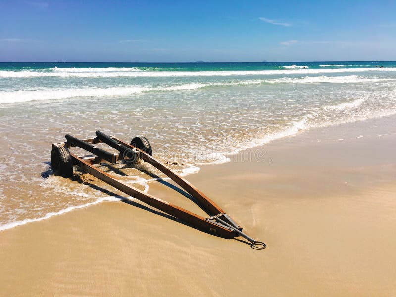 The Wheelbarrow on the Beach with Sea Wave Foam Stock Image - Image of ...