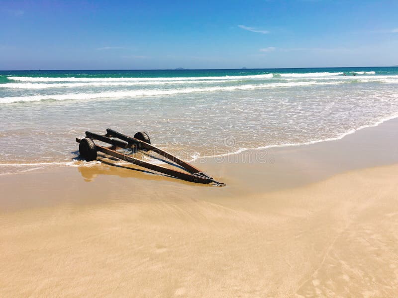 The Wheelbarrow on the Beach with Sea Wave Foam Stock Image - Image of ...