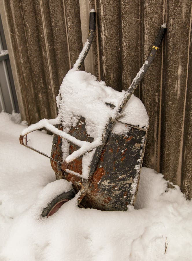 Wheelbarrow at a Construction Site in the Snow in Winter Stock Photo ...