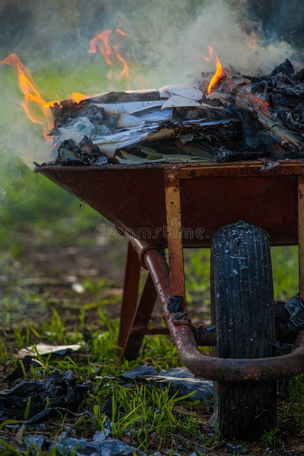 Wheelbarrow Full of Burning Paper Stock Photo - Image of wheelbarrow ...