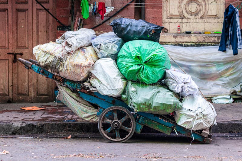 Wheelbarrow Full of Garbage on the Side of a Street. Stock Photo ...