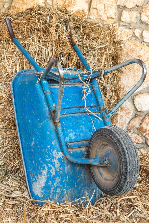 A Wheelbarrow Standing Vertical Stock Photo - Image of lawn, stack ...