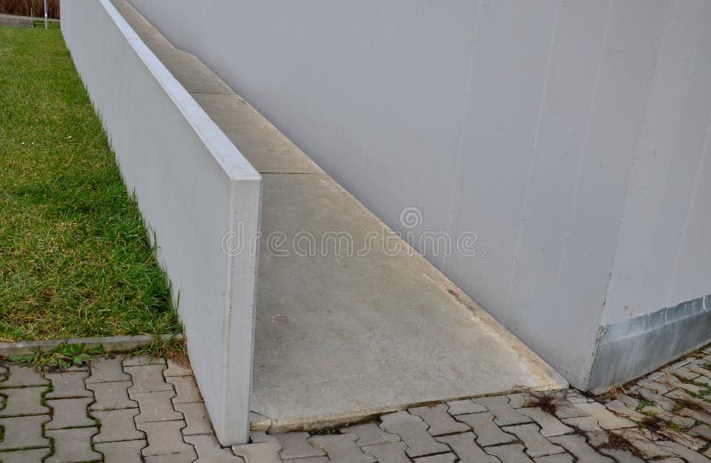 A Bridge Railing with Vertical Fence Posts Anchored into the Ground ...