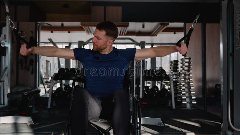 Wheelchair User Using Cable Machine for Strength Training Stock Footage ...