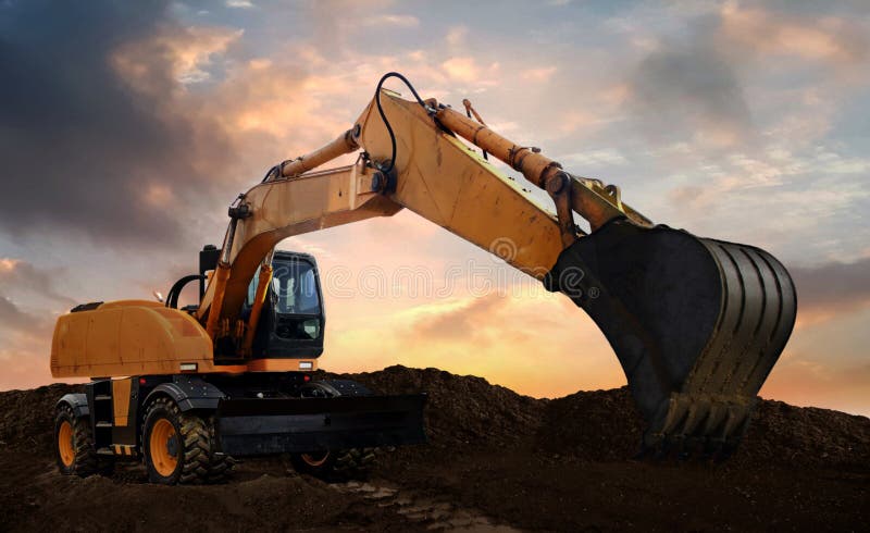 Wheeled Excavator at Work Digging Soil during Sunset Stock Image ...