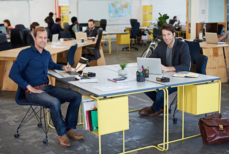 This is Where we Do Our Best Work. Portrait of Colleagues Sitting at a ...