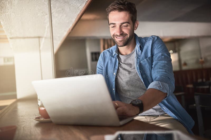 Where he Gets His Best Work Done. a Handsome Young Man Using a Laptop ...