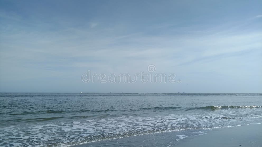 Where the Sea Meets the Shore Stock Photo - Image of clouds, mudflat ...