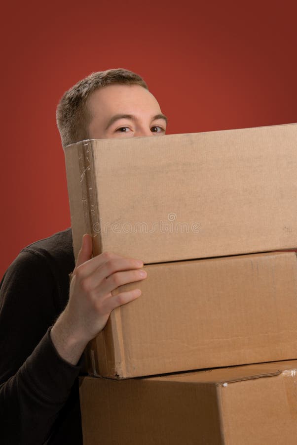 Young Worker In Working Clothes, Carrying A Box. Looked From Behind ...