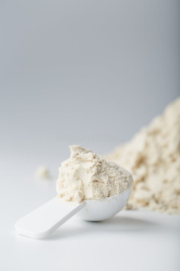 Whey Protein Isolate with a Measuring Spoon on a White Background ...