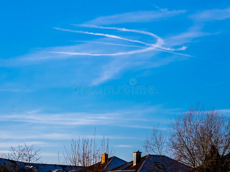 A Whimsical Figure in the Blue Sky, Drawn by an Airplane Stock Image ...