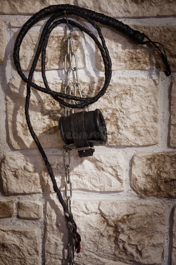 Whip and Handcuffs on the Wall Stock Photo - Image of sadomasochism ...