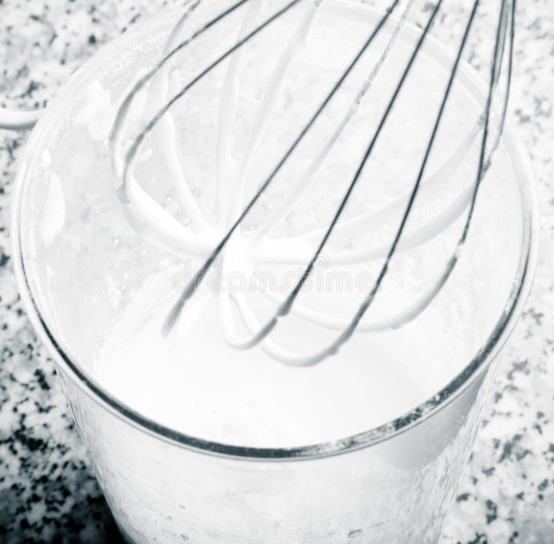 Whisk and Whipped Cream in a Tall Glass on the Kitchen Table. To Stock ...