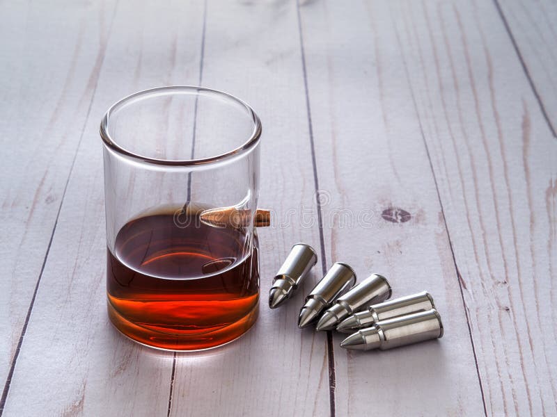 Whiskey glass with bullet stock image. Image of drink - 121687705