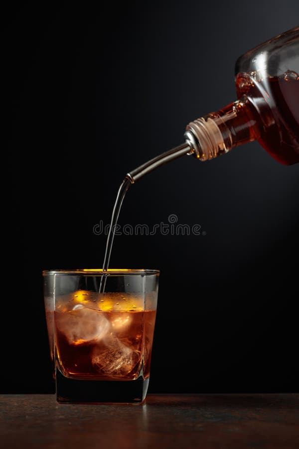 Whiskey is Poured into a Glass with Ice Stock Photo - Image of closeup ...