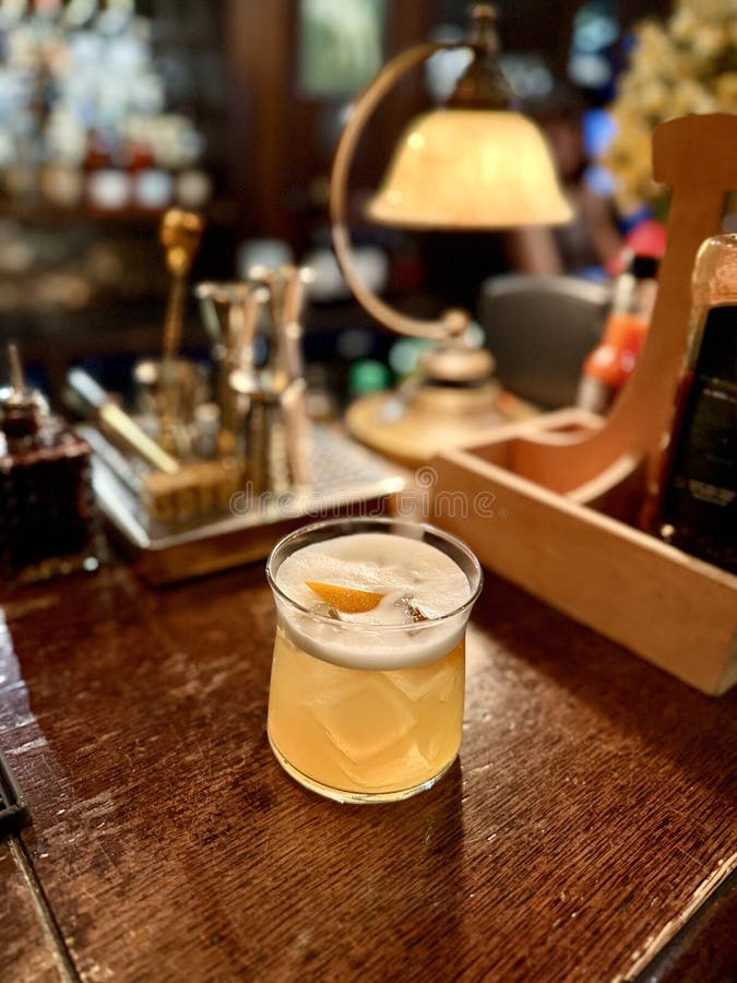 Whiskey Sour Cocktail at Pub Bar with Orange Peel Stock Photo - Image ...