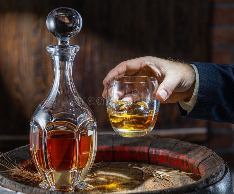 Whisky Tasting. Man Sits in Front of a Barrel with a Decanter and a ...