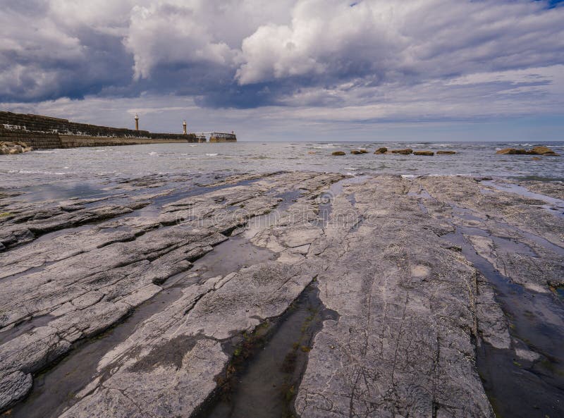 Whitby East Pier and beach stock photo. Image of seascape - 334284356