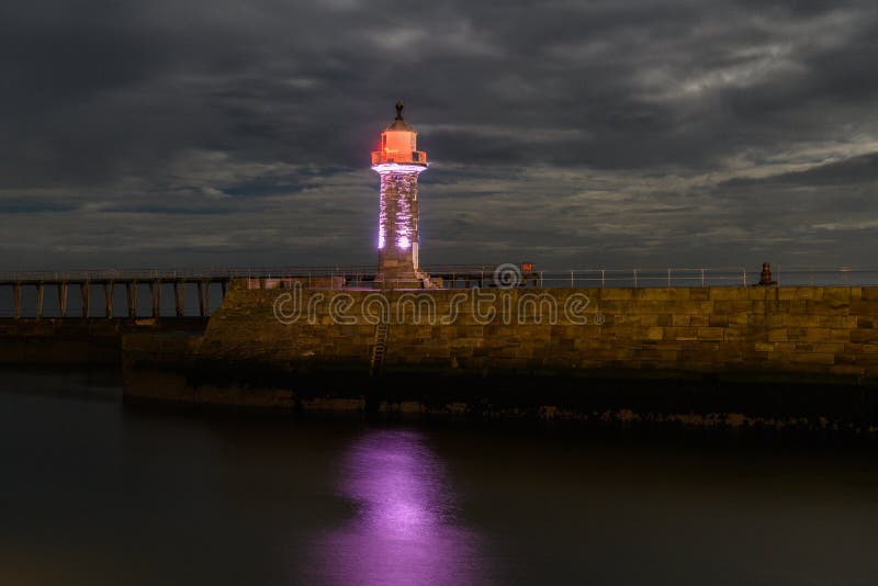 Whitby Lighthouse at night stock photo. Image of light - 135154780