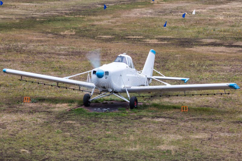 White Aircraft for Spraying Agricultural Fields at the Airfield with a ...