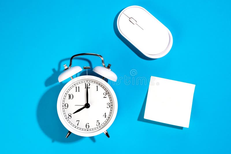 White Alarm Clock and Blank White Paper Sticker on a Blue Background ...