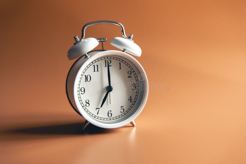 White Alarm Clock and Green Book in a White Bed, Top View. Stock Photo ...