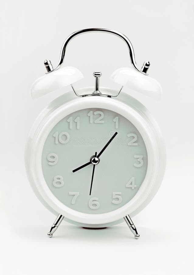 White Alarm Clock and Green Book in a White Bed, Top View. Stock Photo ...